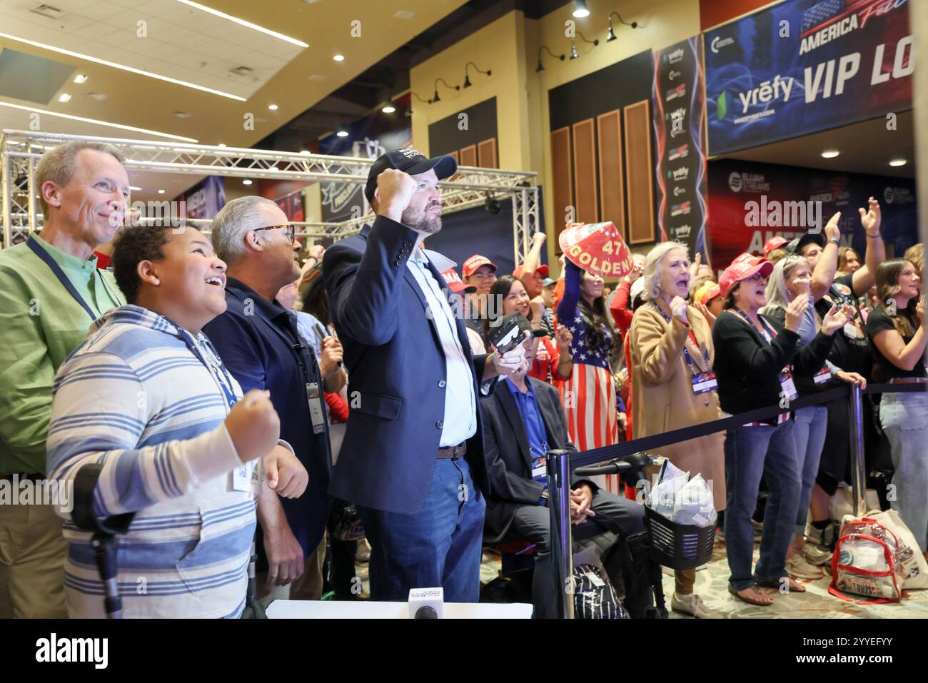 Phoenix, USA. 21st Dec, 2024. People cheer as they gather around to ...