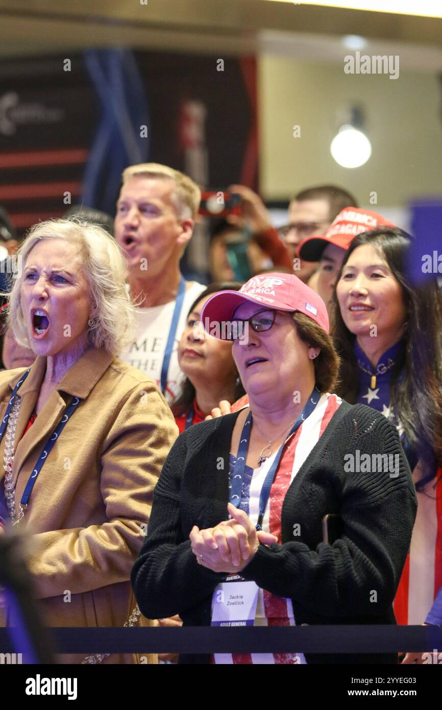 Phoenix, USA. 21st Dec, 2024. People cheer as they gather around to ...