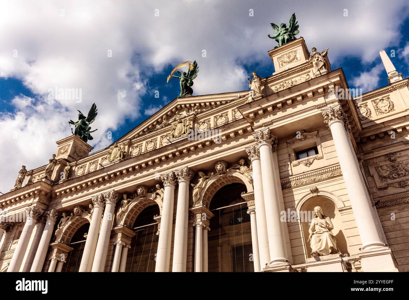 The building is very tall and has a lot of statues on it. The sky is ...