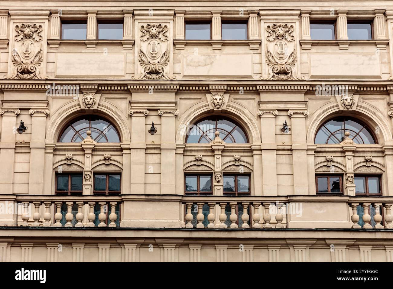 The building has a lot of windows and a balcony. The windows are large ...