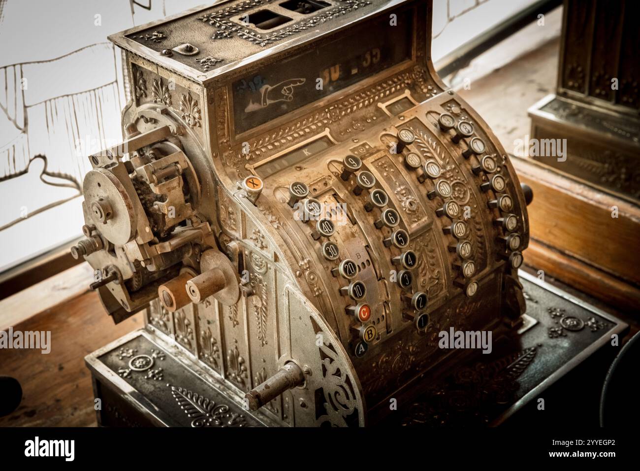 An old fashioned cash register with a wooden base. The register is old ...