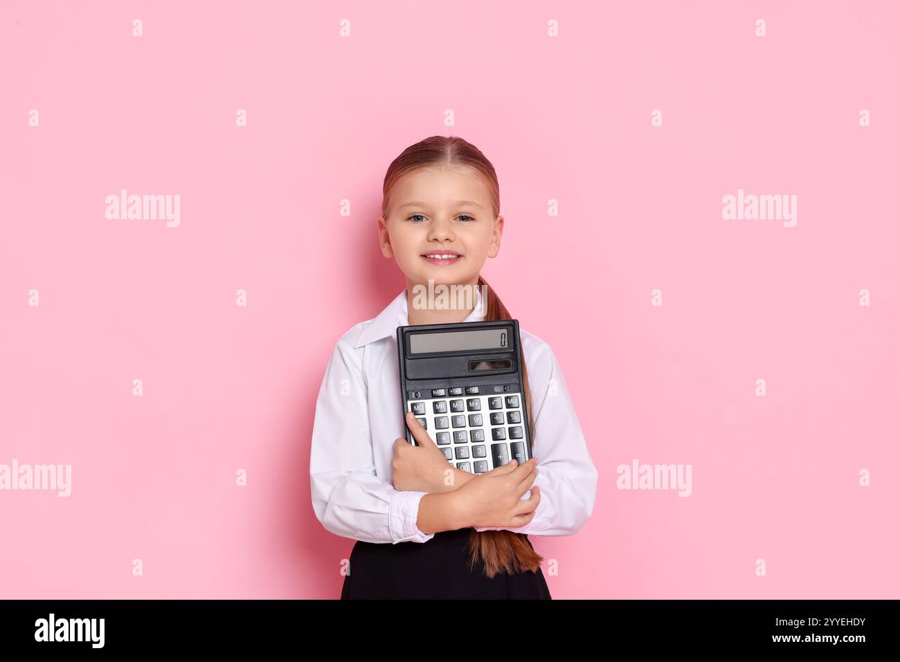 Little girl with calculator pretending to be accountant on pink ...