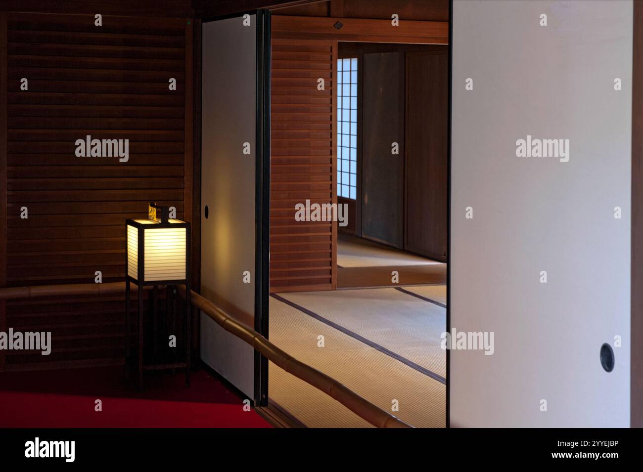 Washi paper and wood frame floor lantern casts a gentle glow in a ...