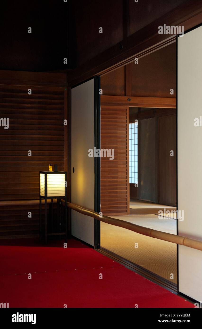 Washi paper and wood frame floor lantern casts a gentle glow in a ...