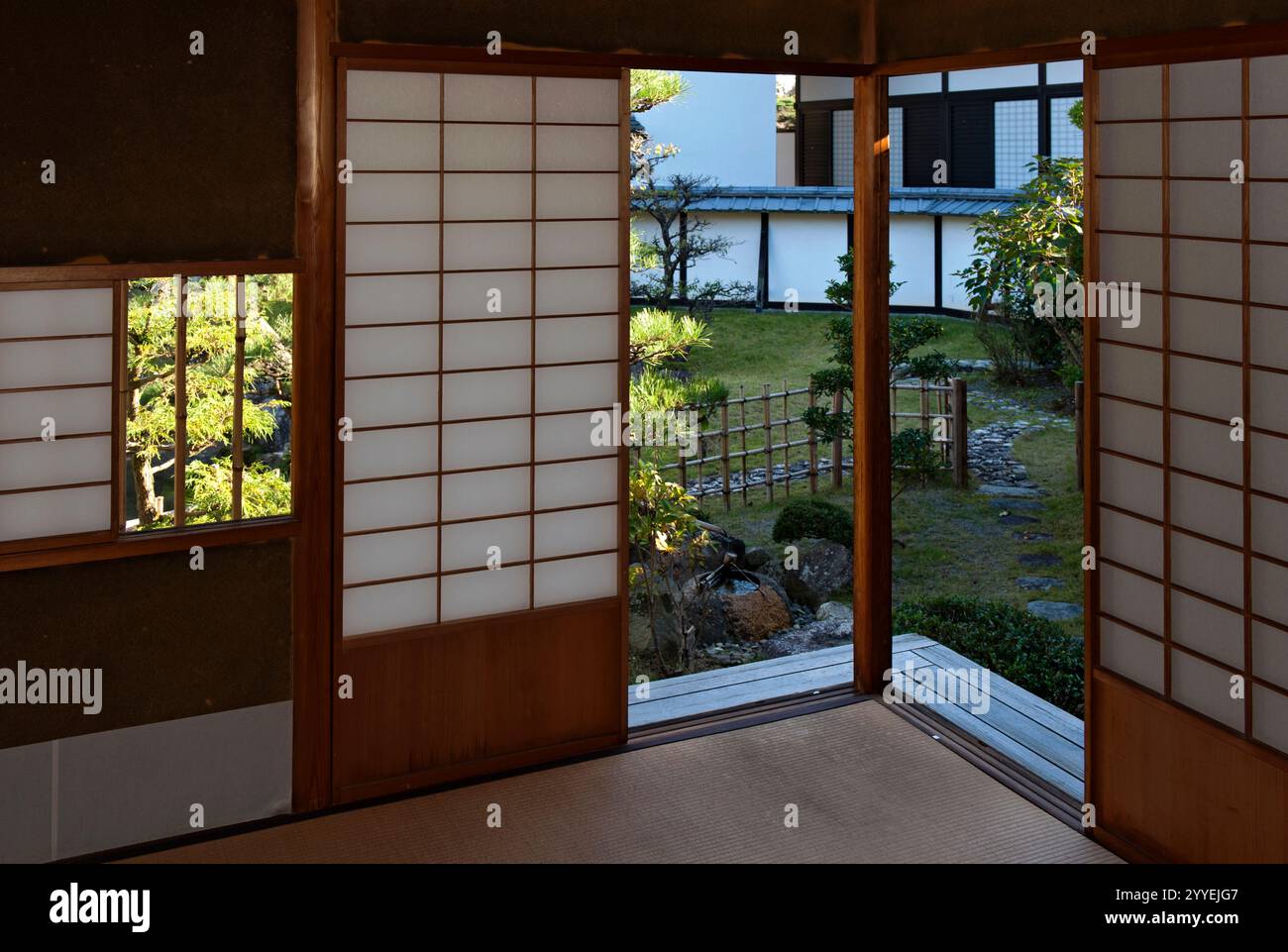 View through open shoji sliding paper screens of a Japanese landscape ...