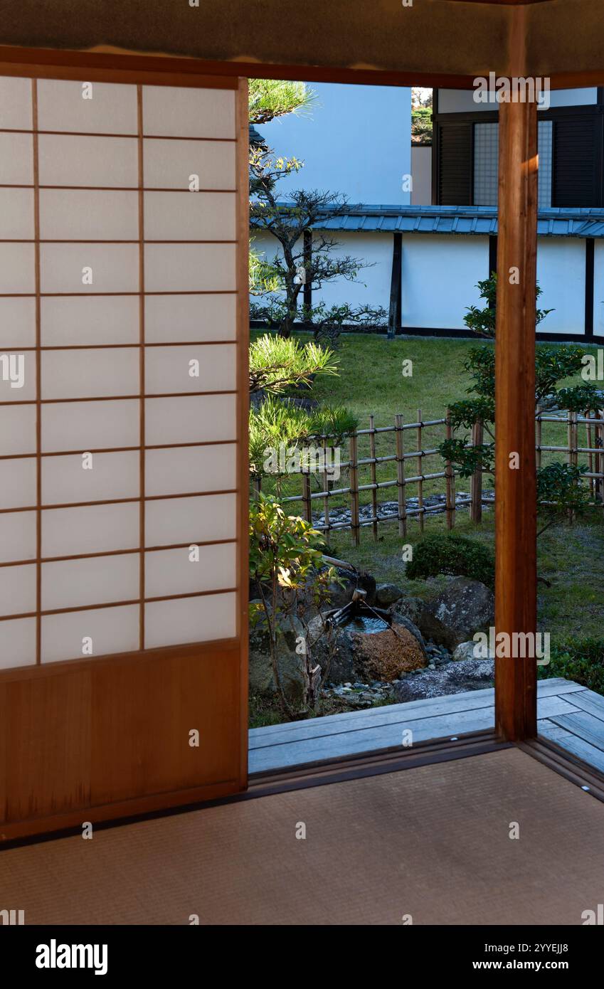 View through open shoji sliding paper screens of a Japanese landscape ...