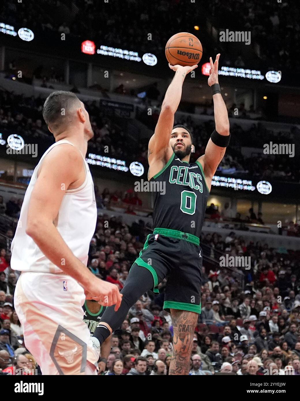 Boston Celtics' Jayson Tatum shoots as Chicago Bulls' Nikola Vucevic ...