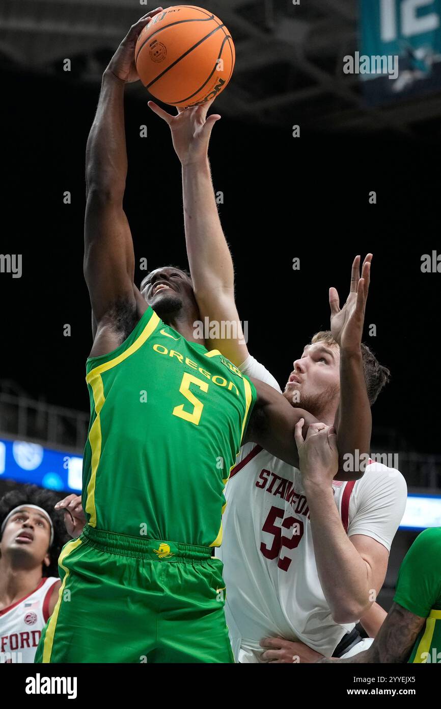 Oregon guard TJ Bamba (5) grabs a rebound over Stanford forward Aidan ...