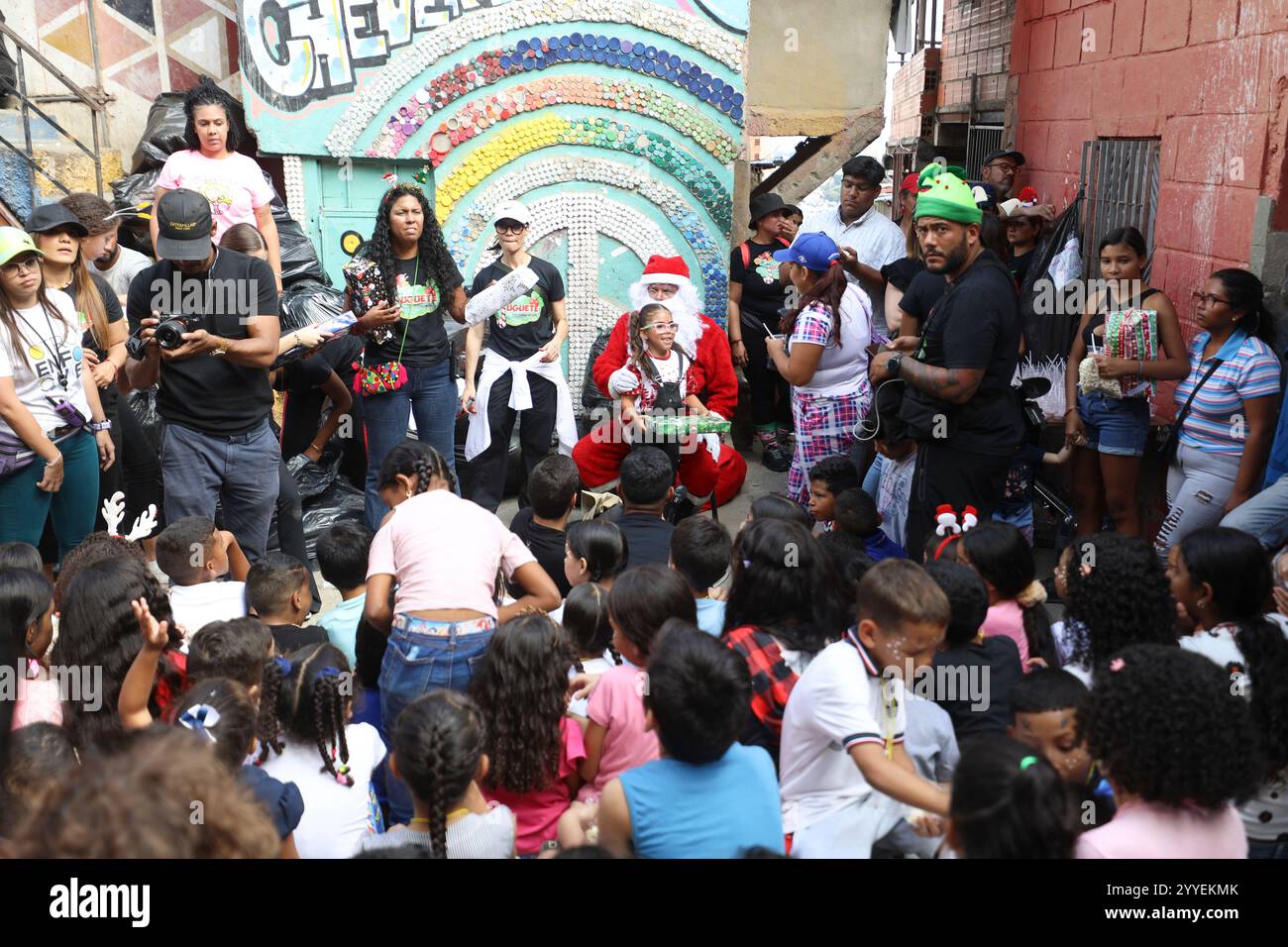 Caracas, Venezuela. 21st Dec, 2024. A man dressed as Santa Claus hands ...