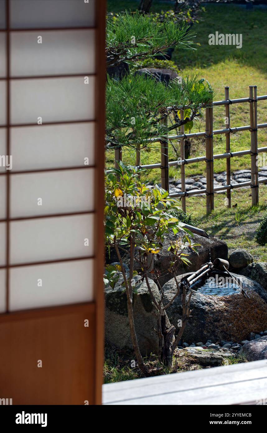 View through open shoji sliding paper screens of a Japanese landscape ...