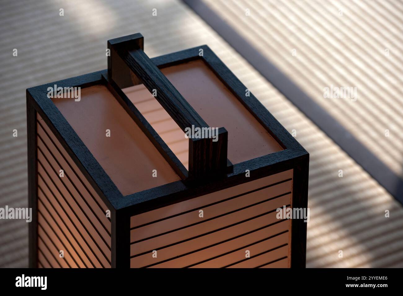 Washi paper and wood frame floor lantern casts a gentle glow in a ...
