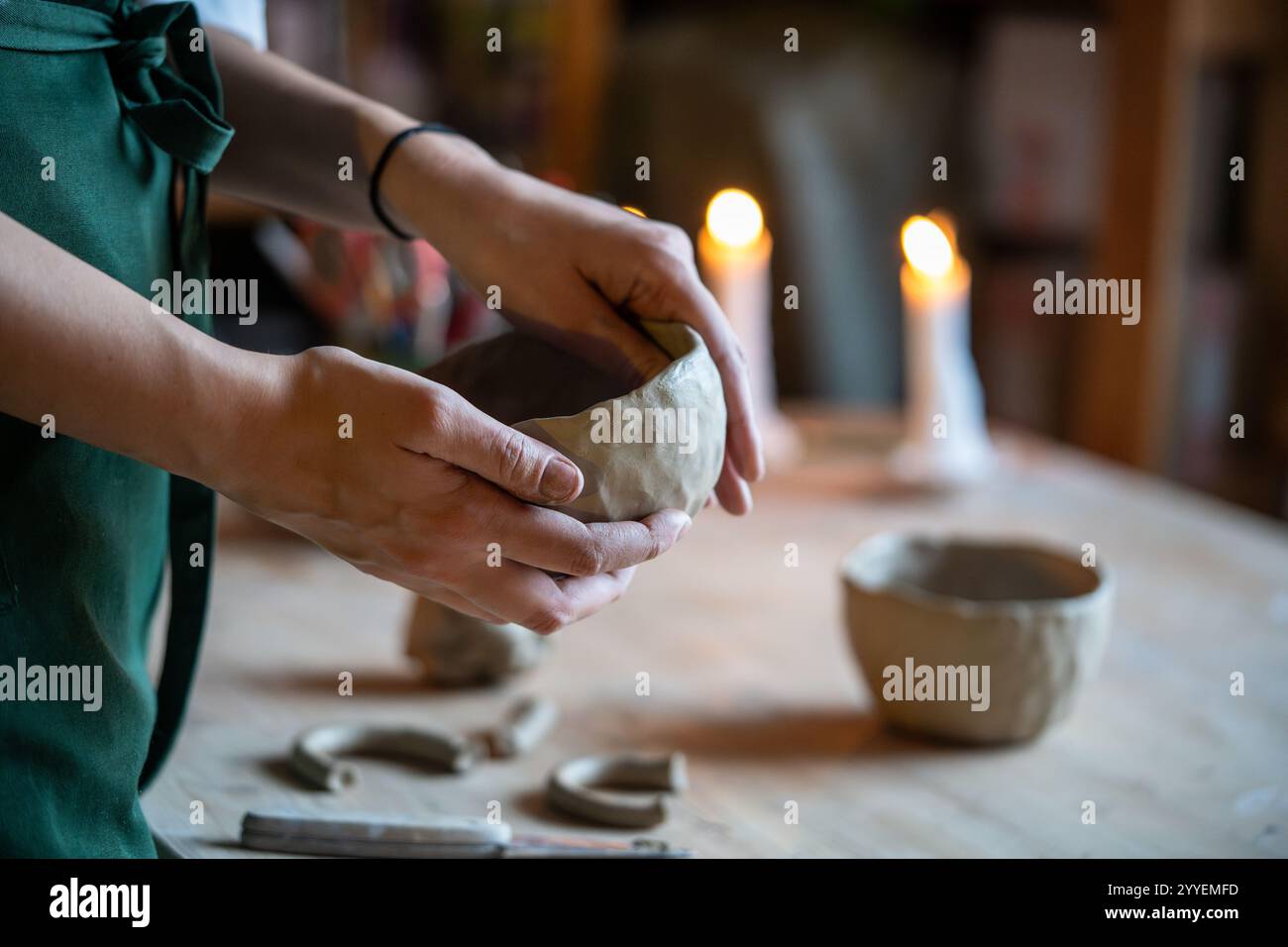 Woman potter sculpting clay pot with hand. Ceramist work with raw ...