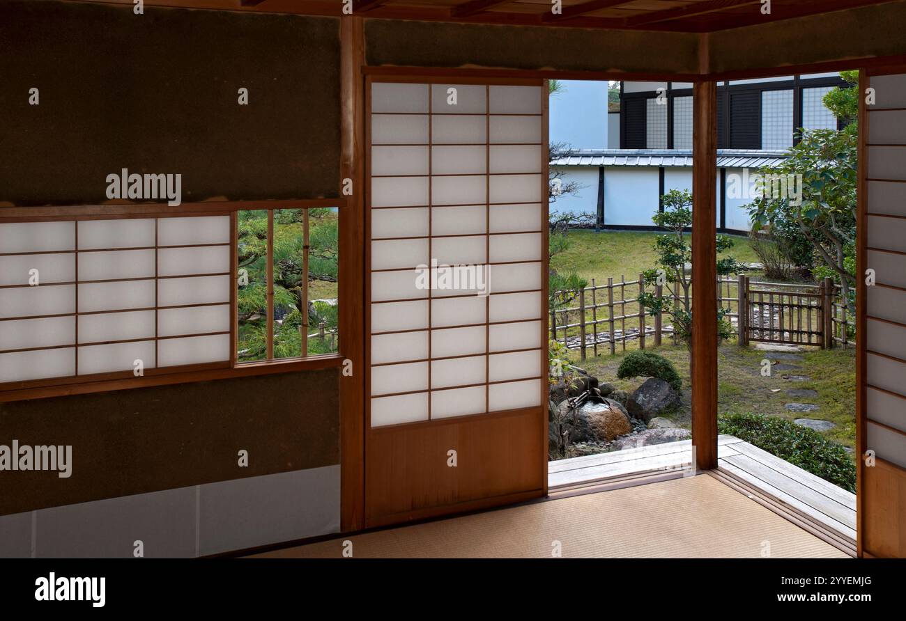 View through open shoji sliding paper screens of a Japanese landscape ...