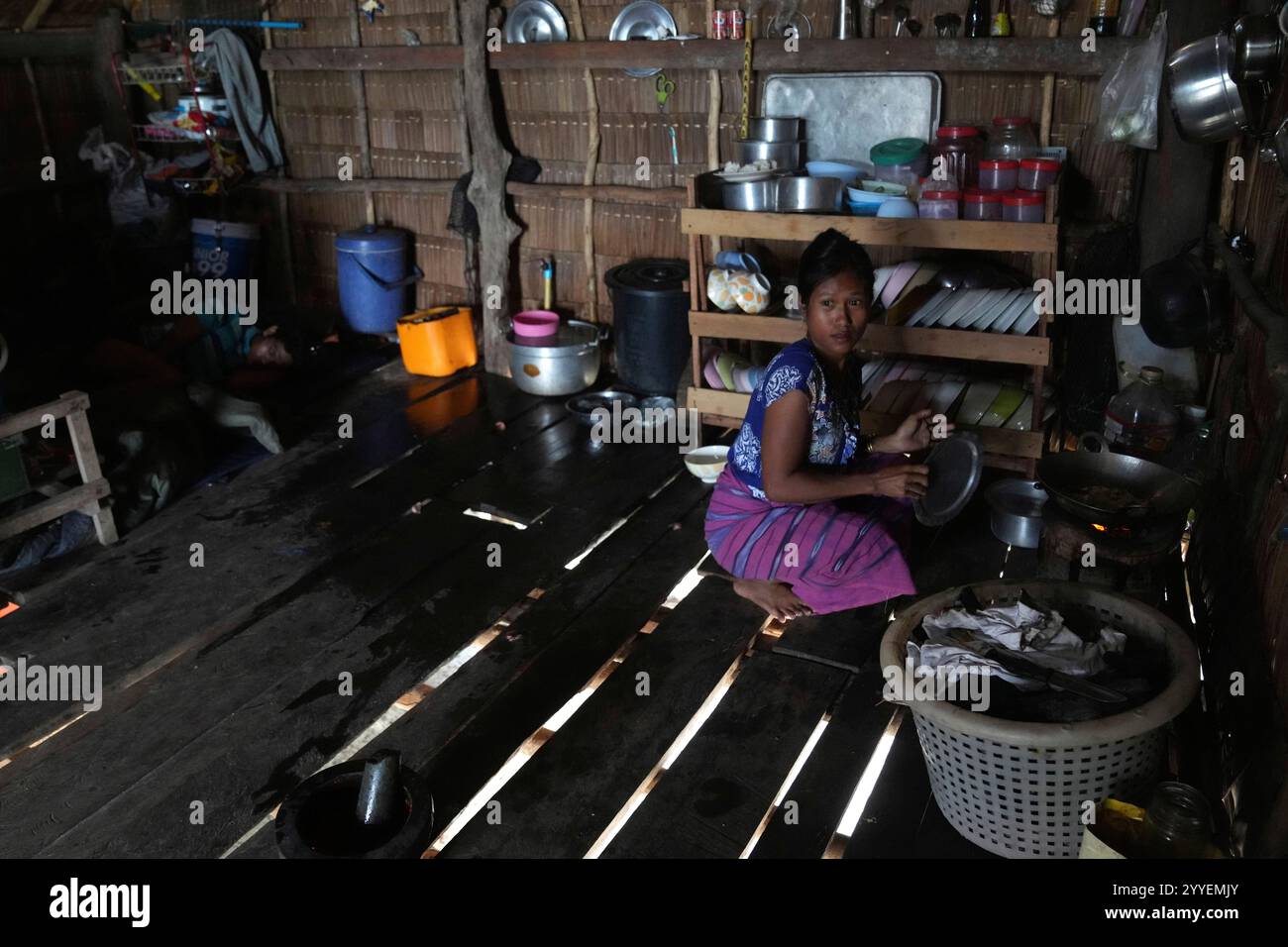 Bonbong Klathale cooks at her house in Moken village at Surin Island in ...