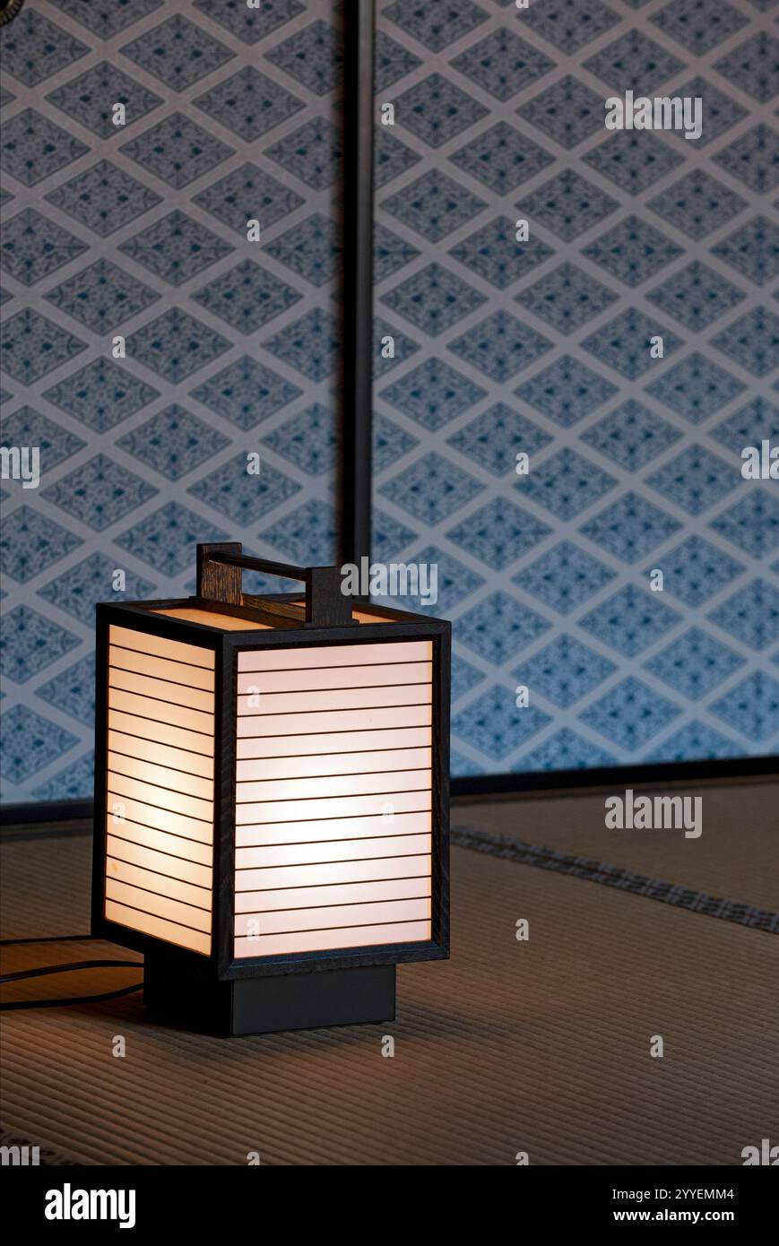 Washi paper and wood frame floor lantern casts a gentle glow in a ...