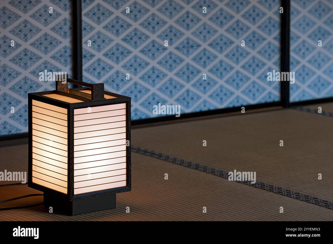 Washi paper and wood frame floor lantern casts a gentle glow in a ...
