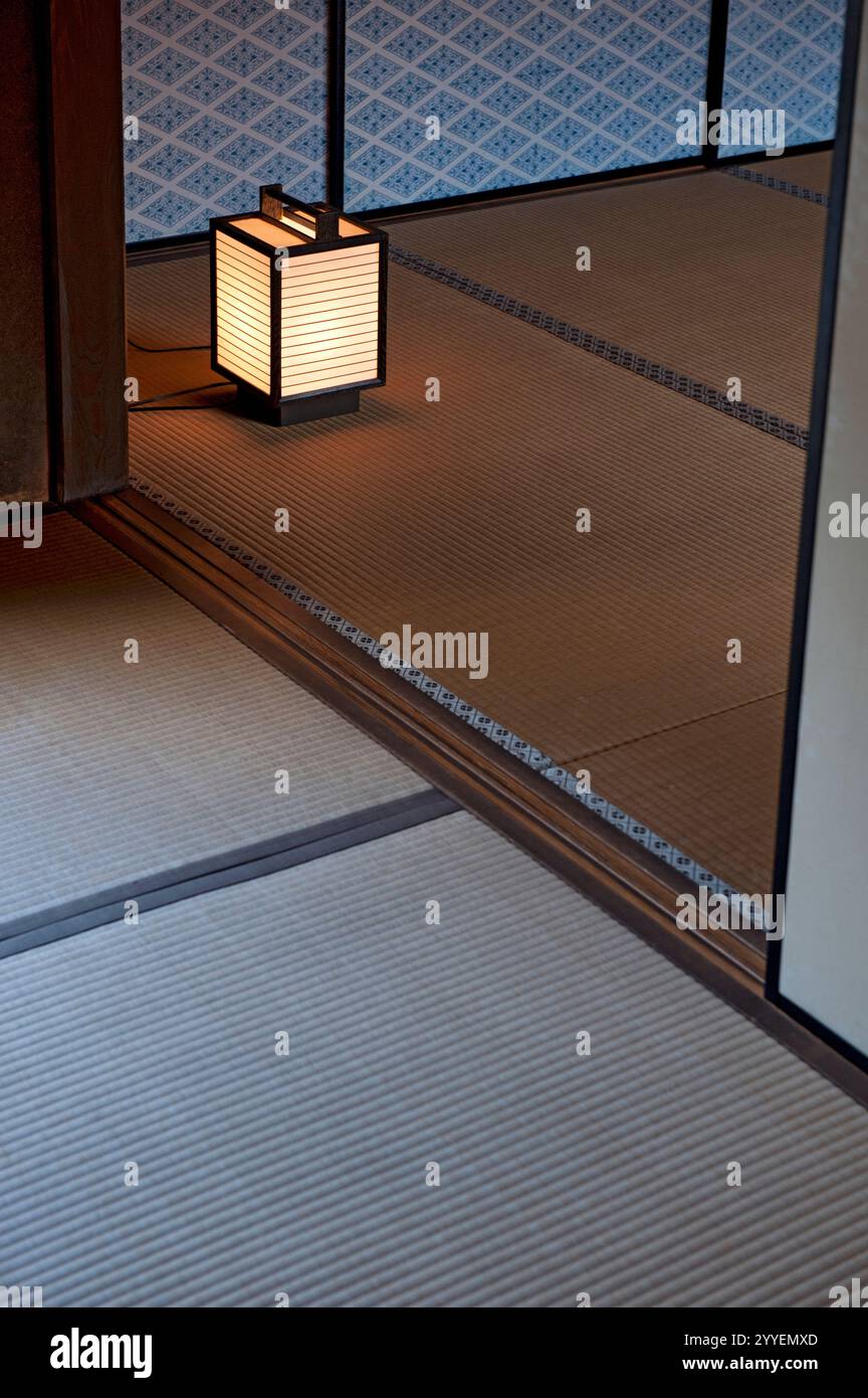 Washi paper and wood frame floor lantern casts a gentle glow in a ...