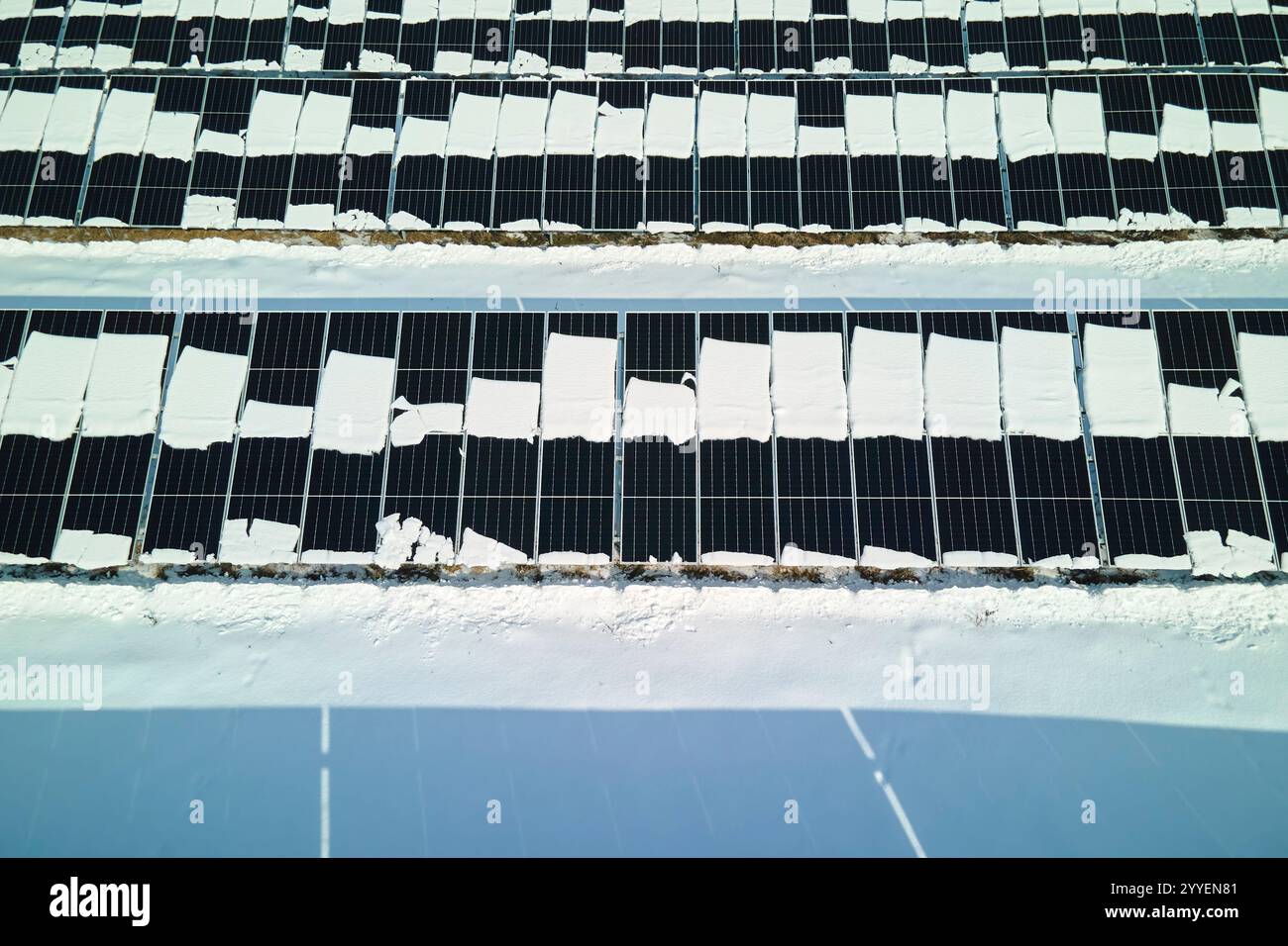 Aerial view of snow melting from covered solar photovoltaic panels at ...