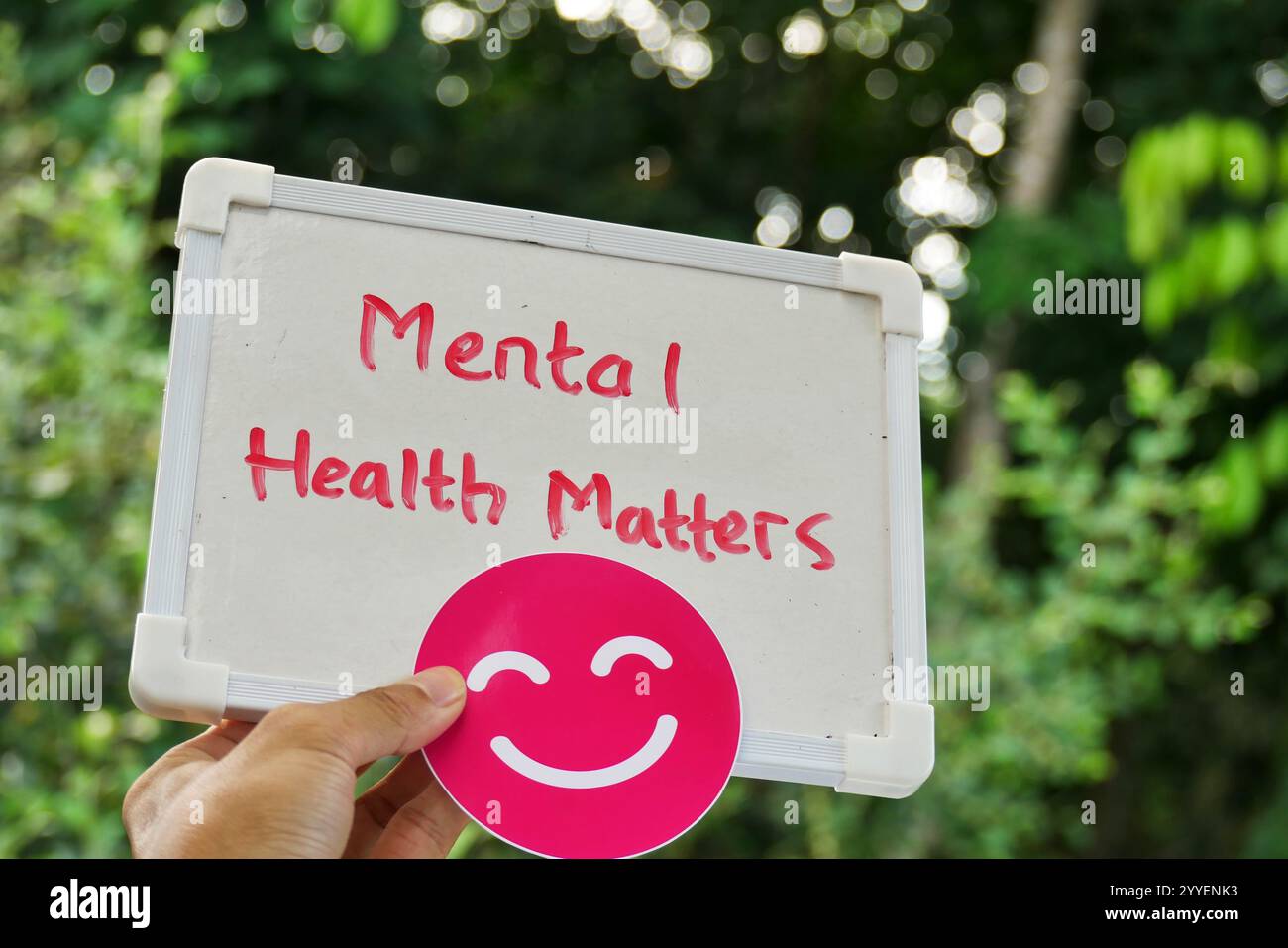 Mental Health matters handwritten on the board and smiley face stickers ...