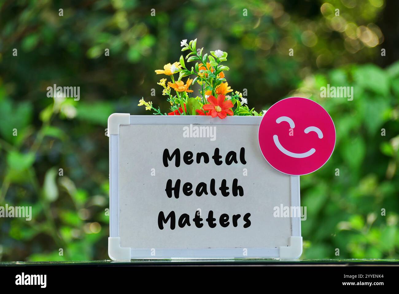 Mental Health matters handwritten on the board and smiley face stickers ...
