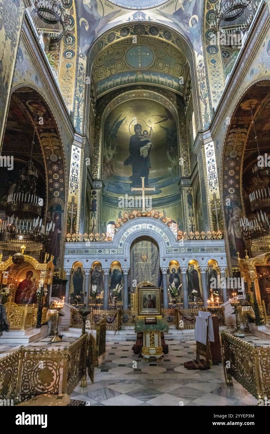 The inside of a church is lit up with candles and the walls are covered ...