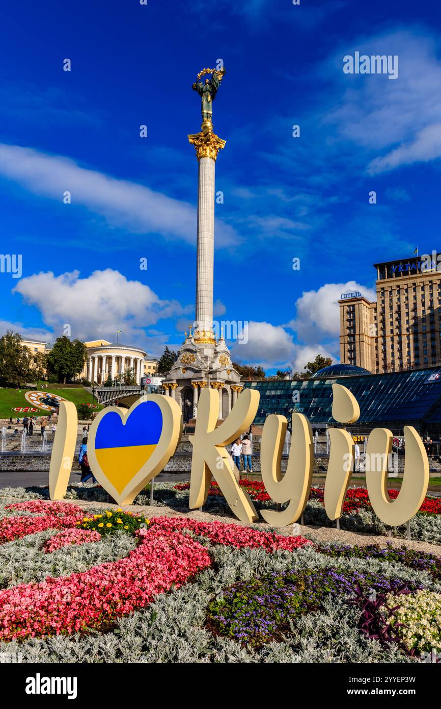 A large, white, and blue sign with the word "I love Kyiv" written on it ...