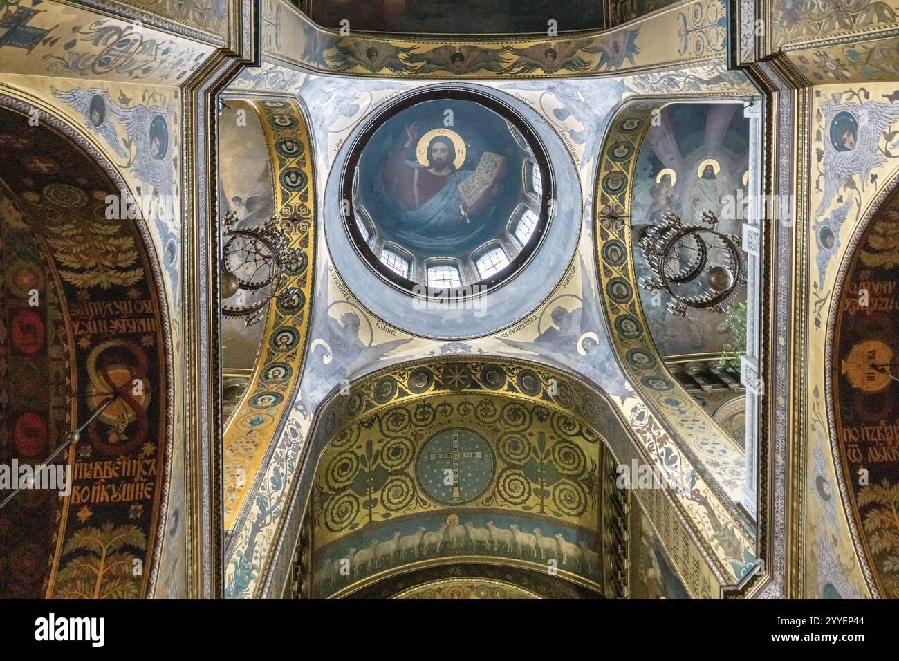 The ceiling of a church is decorated with gold and blue designs. The ...