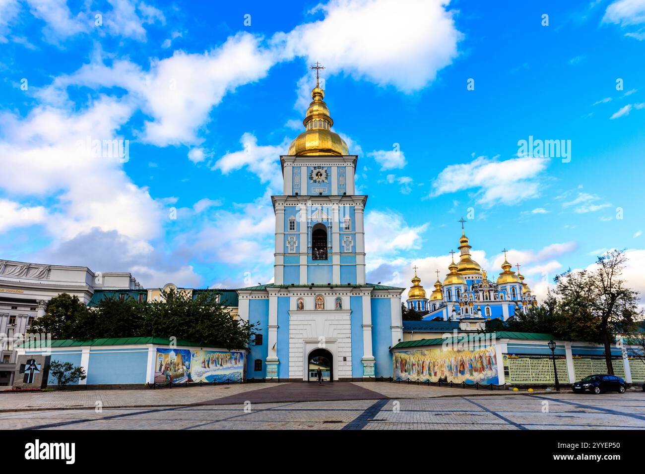 A large building with a gold dome and a bell tower. The building is ...