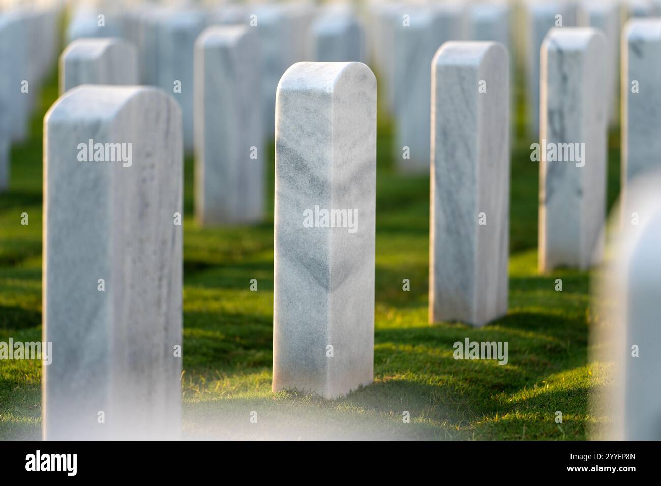 Memorial Day concept. Sarasota National Cemetery with rows of white tomb stones on green grass ...
