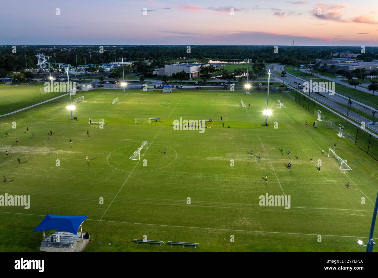 Sportsmen training in soccer game on illuminated football stadium in ...