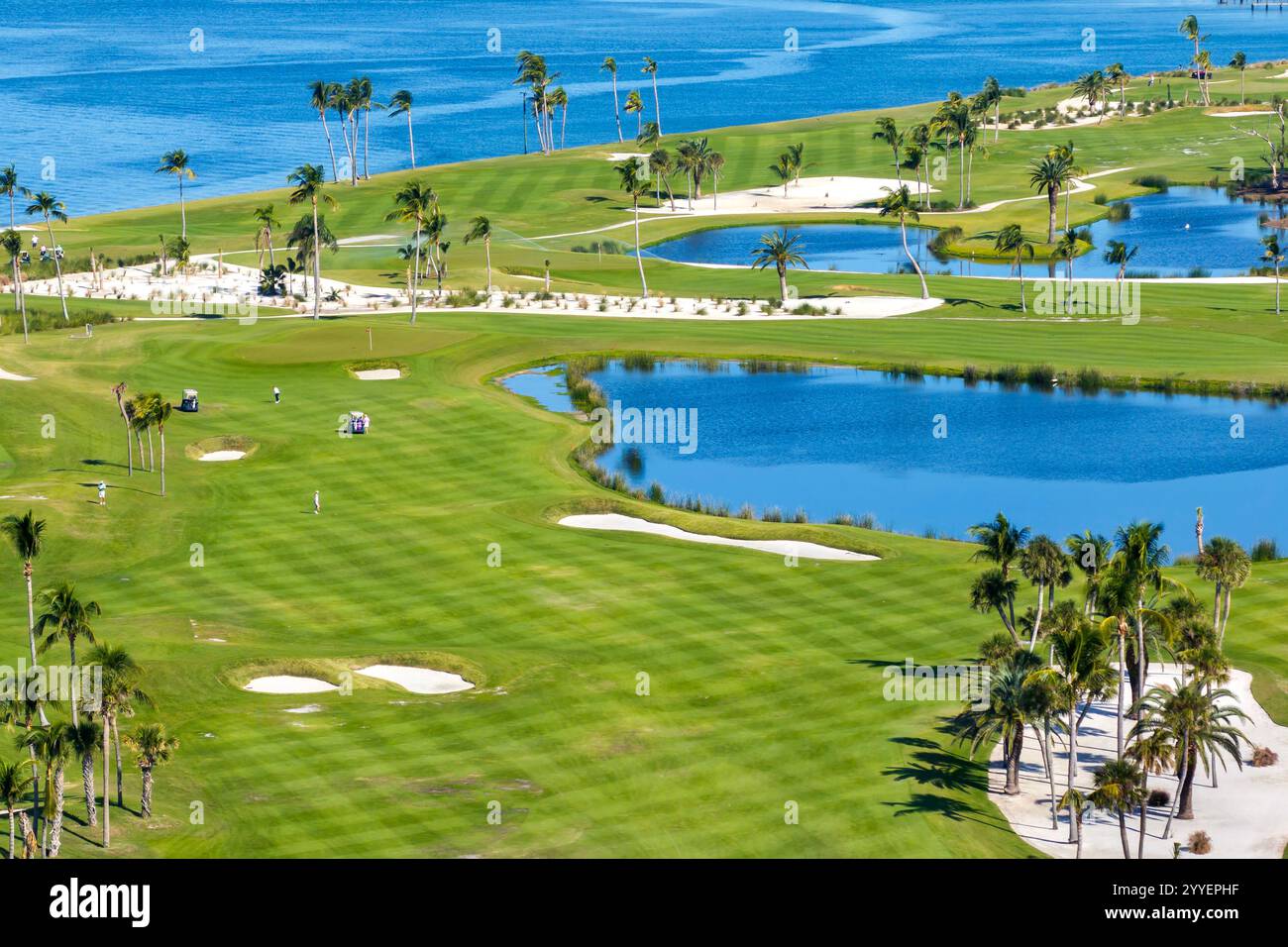 Waterfront golf course in Florida. Sports grounds with green grass in ...