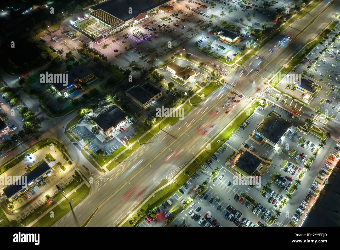 Wide highway with shopping malls and small businesses in North Port ...