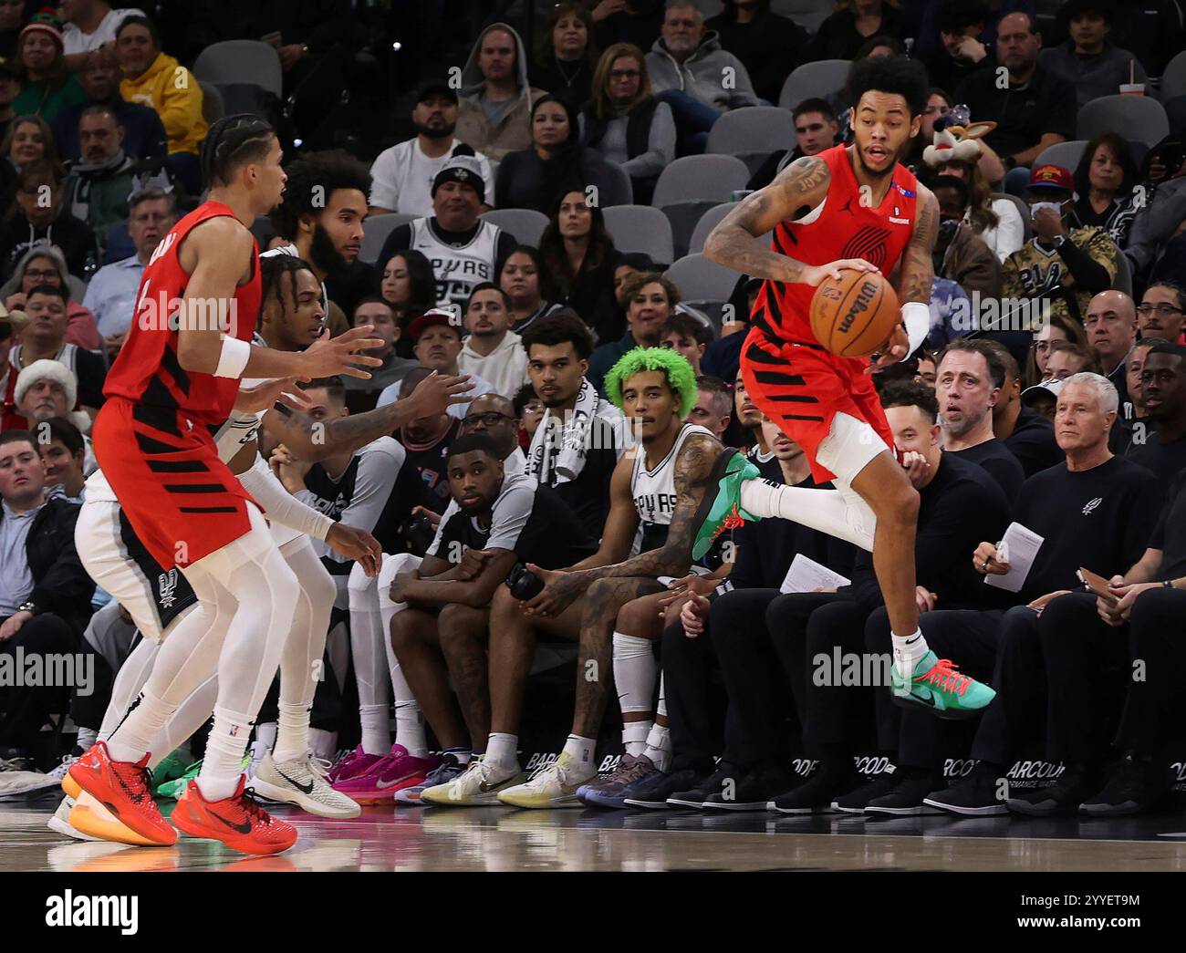 Portland Trail Blazers guard Anfernee Simons, right, saves the ball ...