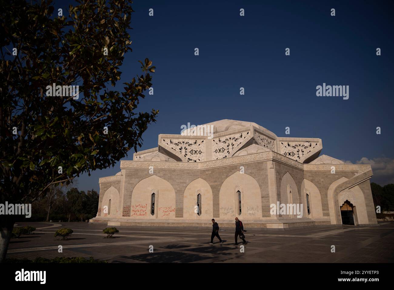 People walk by the mausoleum of Syria's former President Hafez Assad in ...