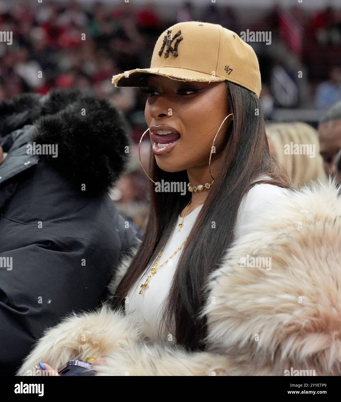 Rapper Meg Thee Stallion poses for photographers and fans during an NBA ...