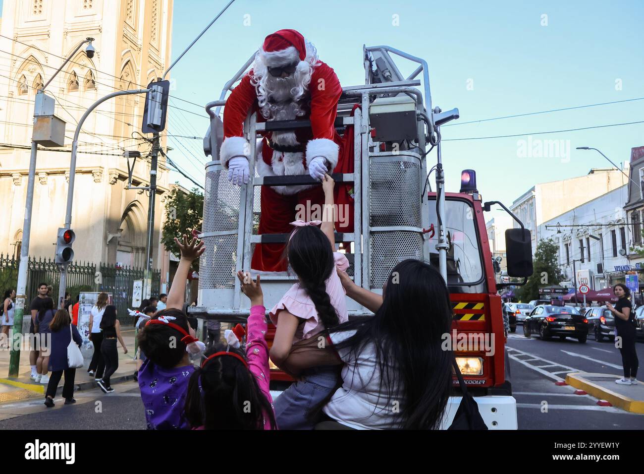 Santa Claus firefighters greet children during the Christmas Caravan in ...