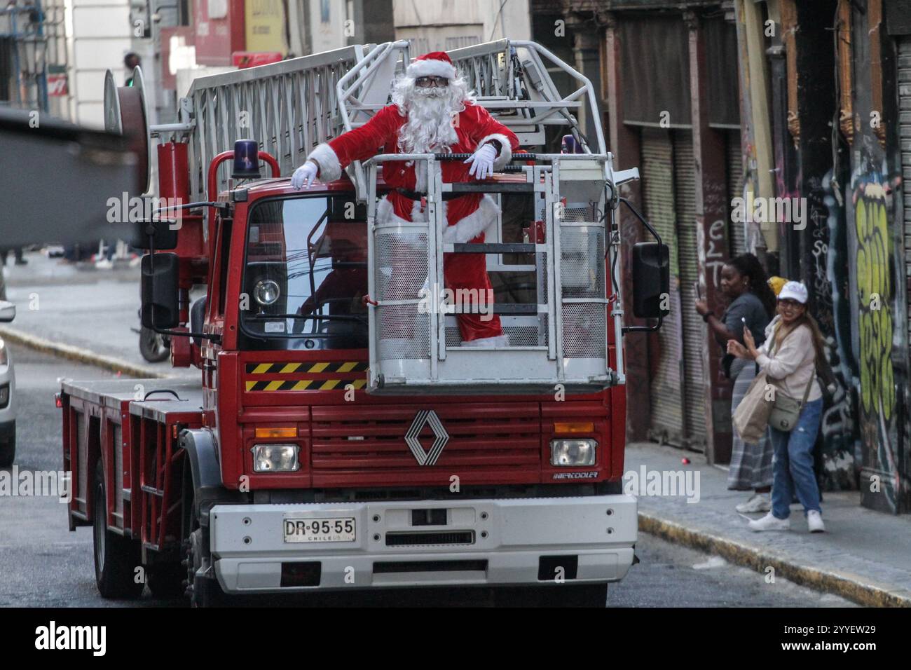Valparaiso, Chile. 21st Dec, 2024. A firefighter is carried on a truck ...