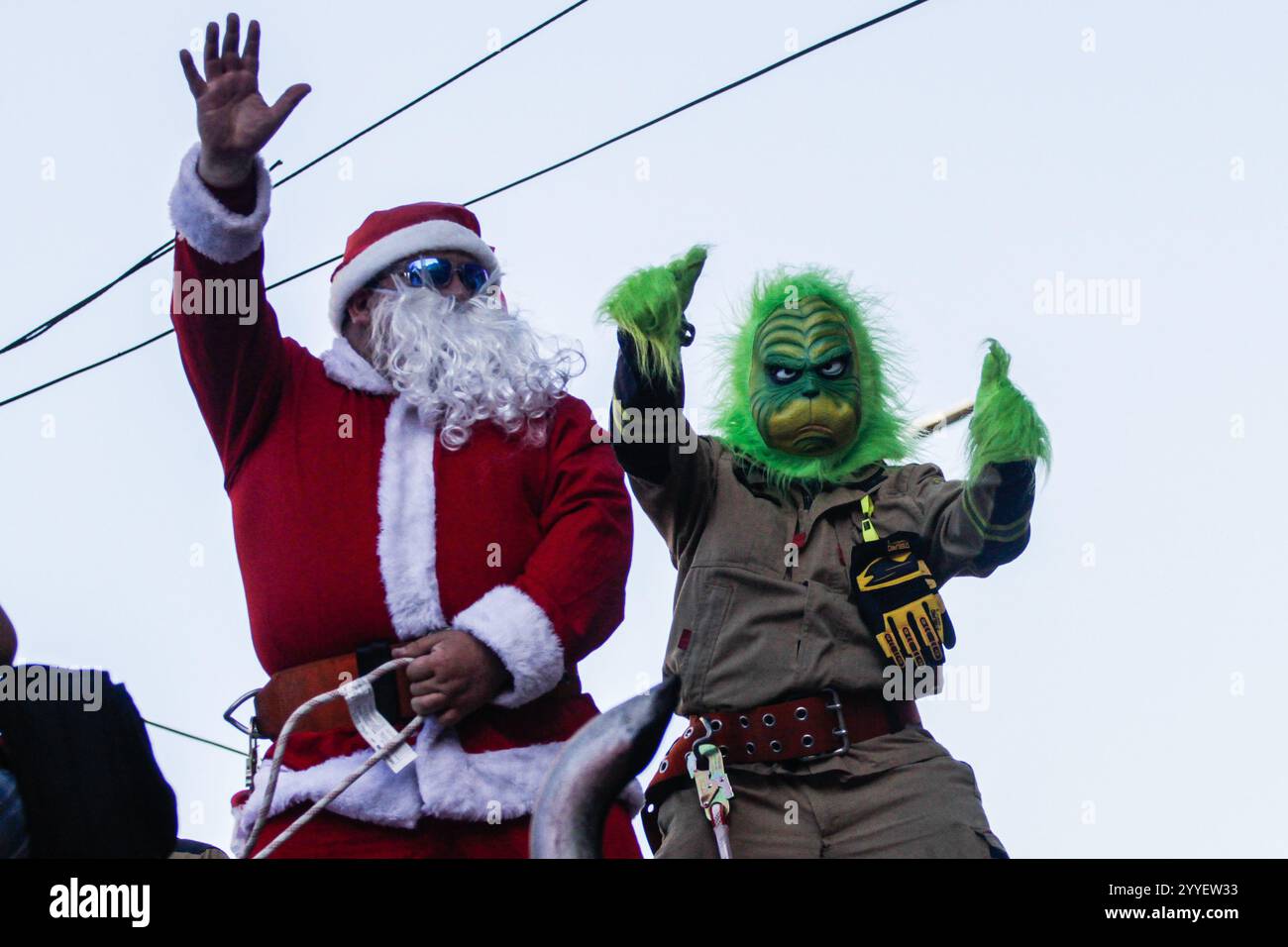 Firefighters in Santa Claus and the Grinch theme during the Christmas ...