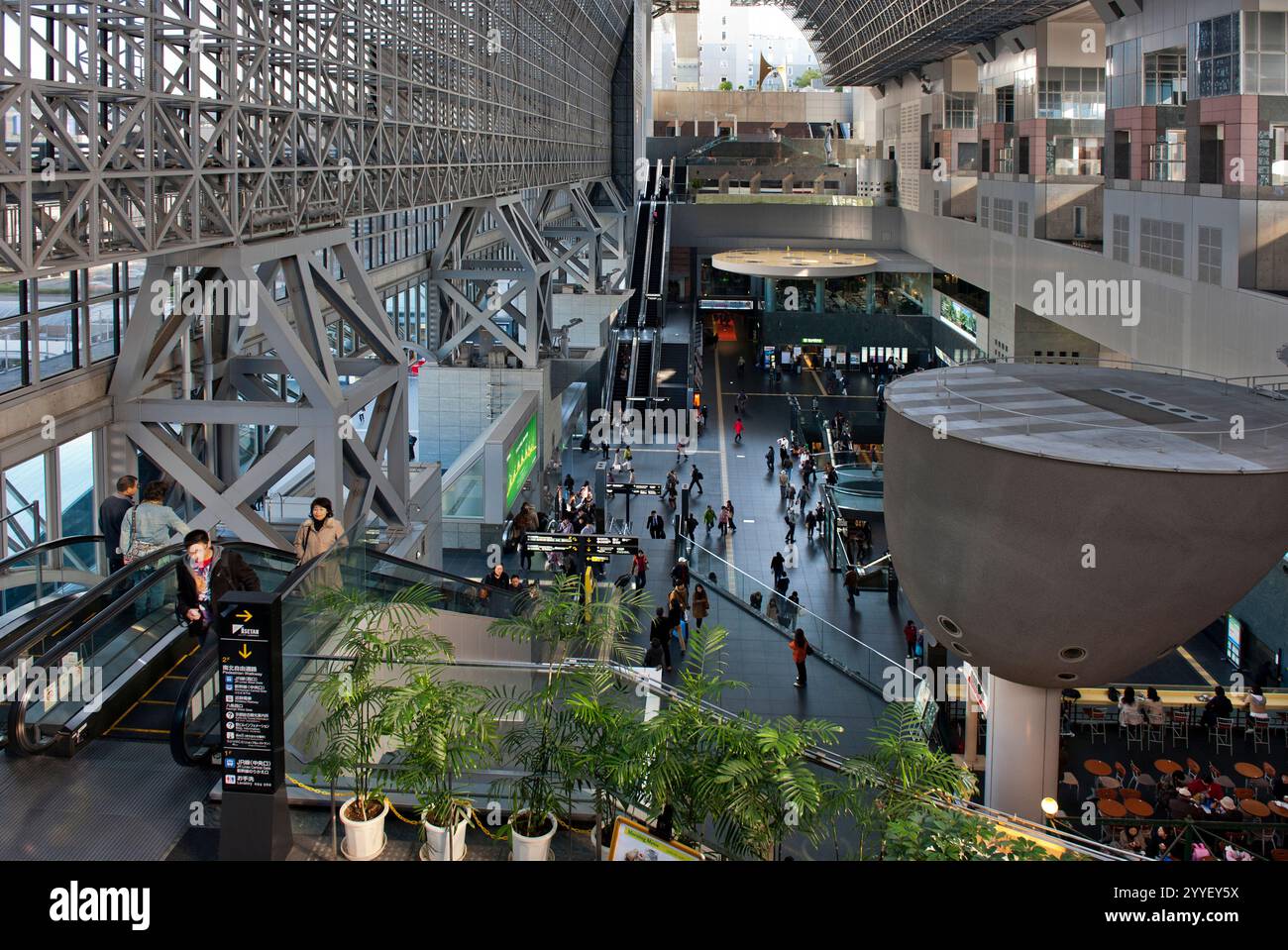 People milling about inside the cavernous interior of the modern JR ...
