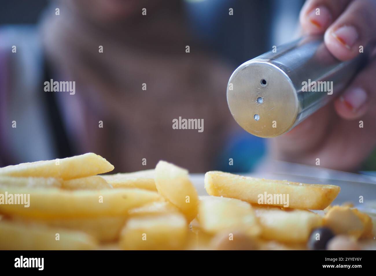 A pinch of salt on French fries enhances the casual dining experience ...