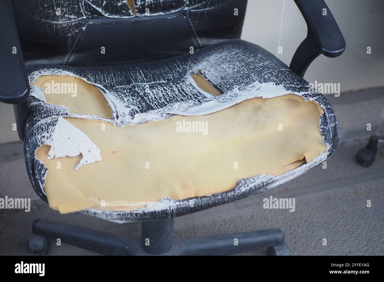 A WornOut Office Chair that has Exposed Foam and is in poor condition ...