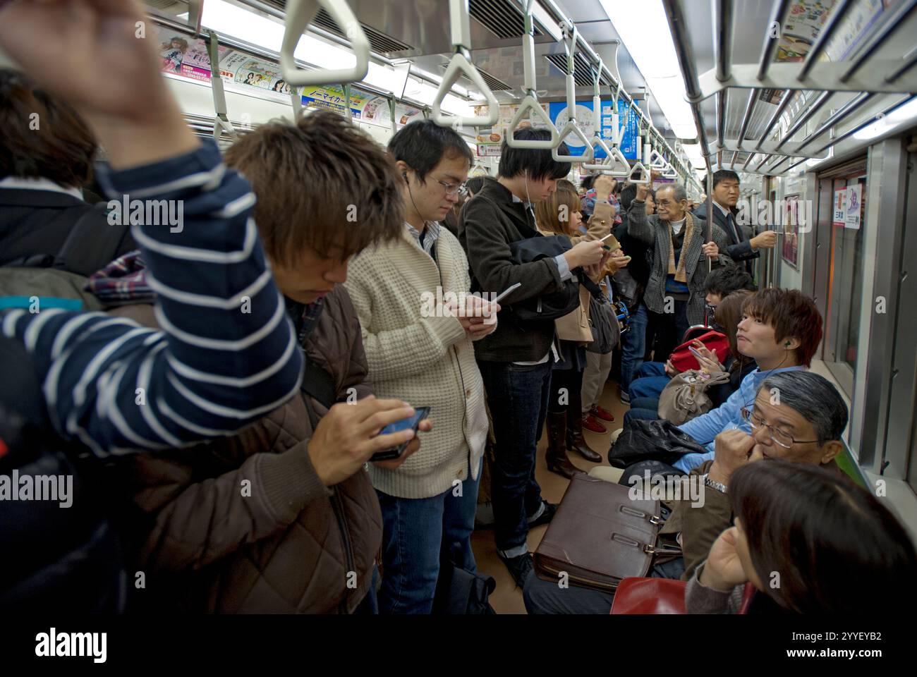 Passengers inside a crowded Kyoto underground subway train carriage ...