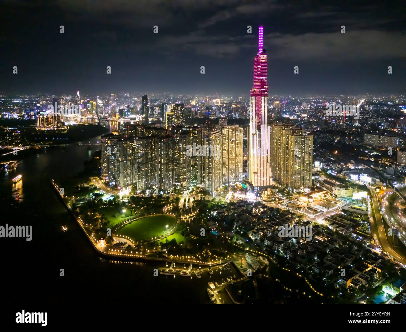 A city at night with a tall building in the middle. The building is lit ...