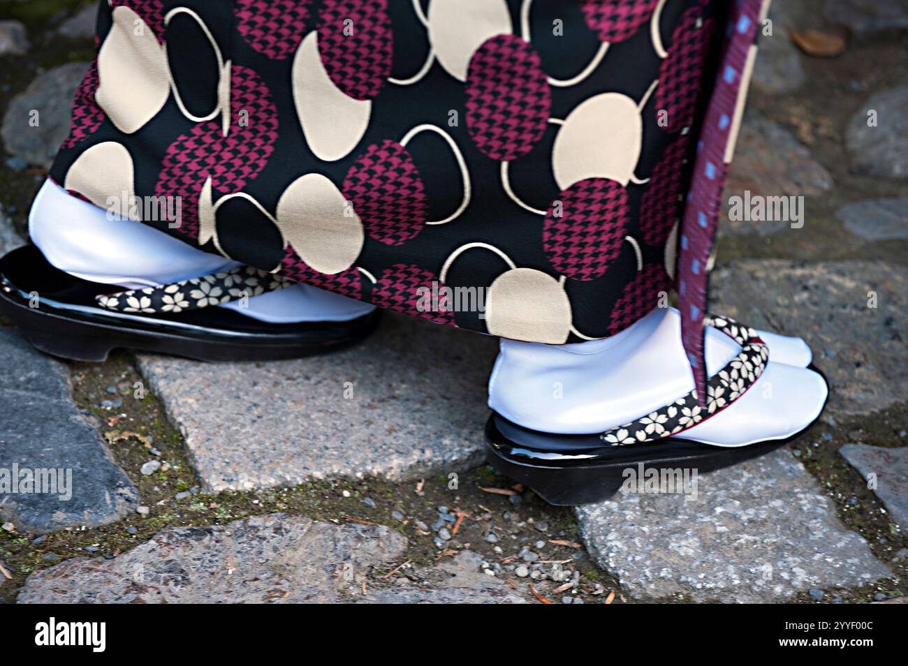 A woman wearing a traditional Japanese kimono with "tabi" (split-toe ...