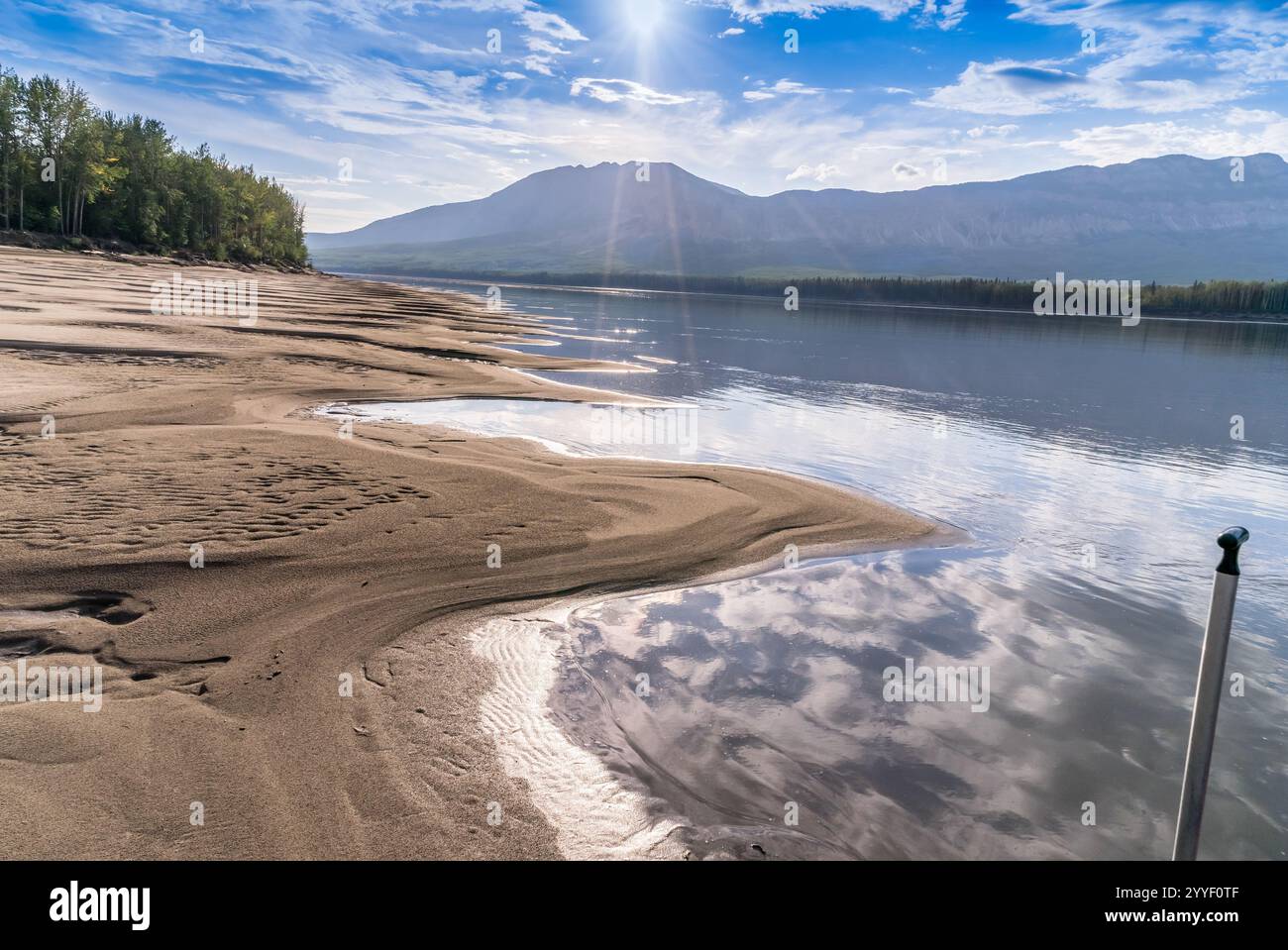Liard river sand beach bank at evening light downstream of Nahanni ...