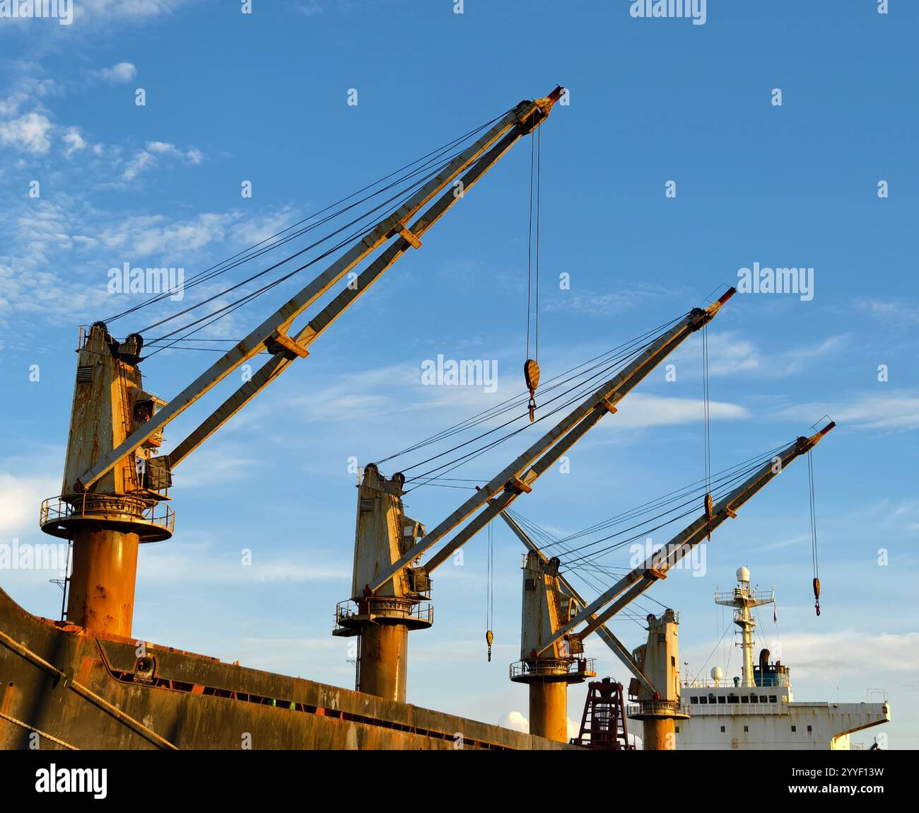 A large ship equipped with cranes mounted on its side Stock Photo - Alamy