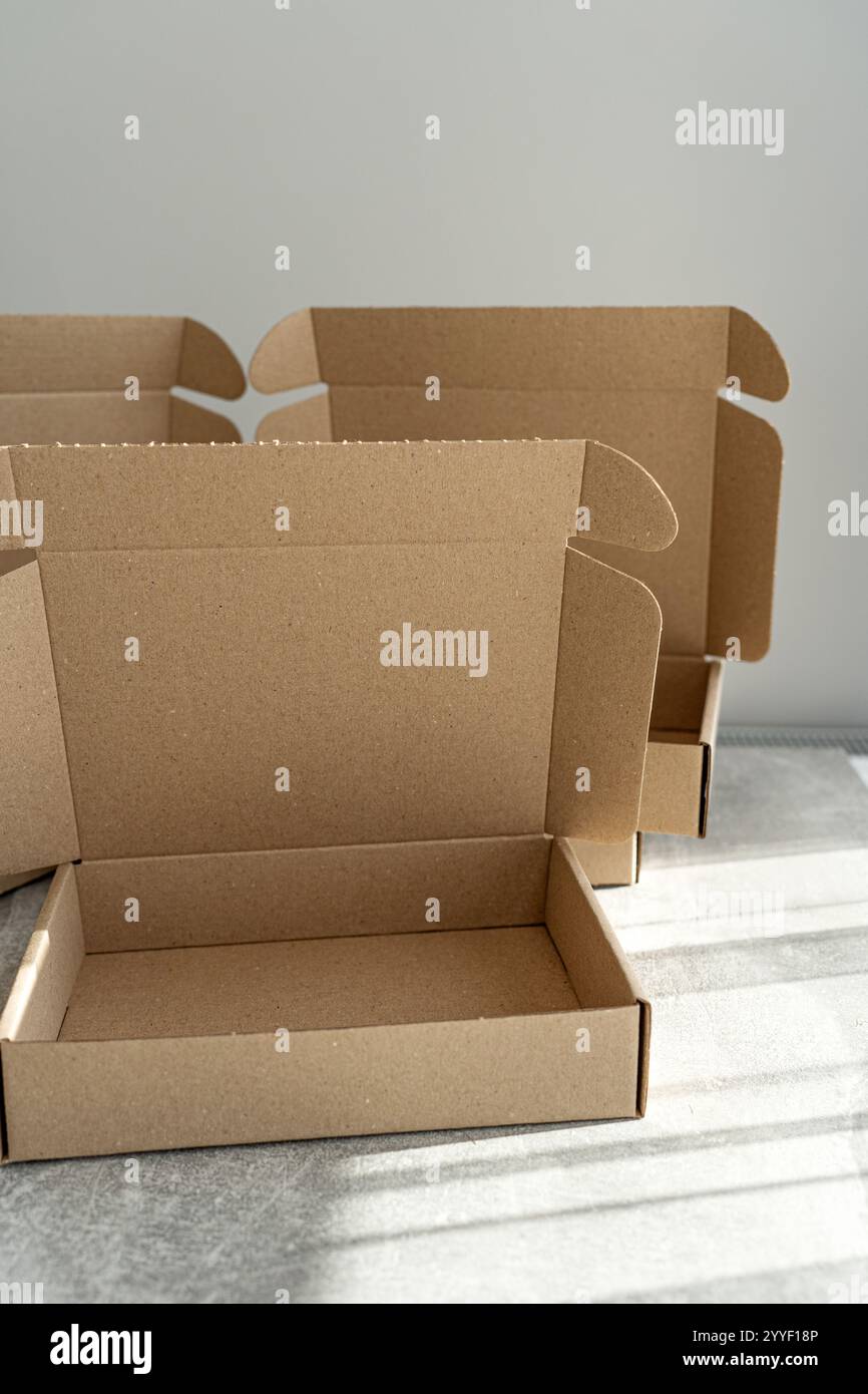 Three kraft cardboard boxes with Stock Photo - Alamy