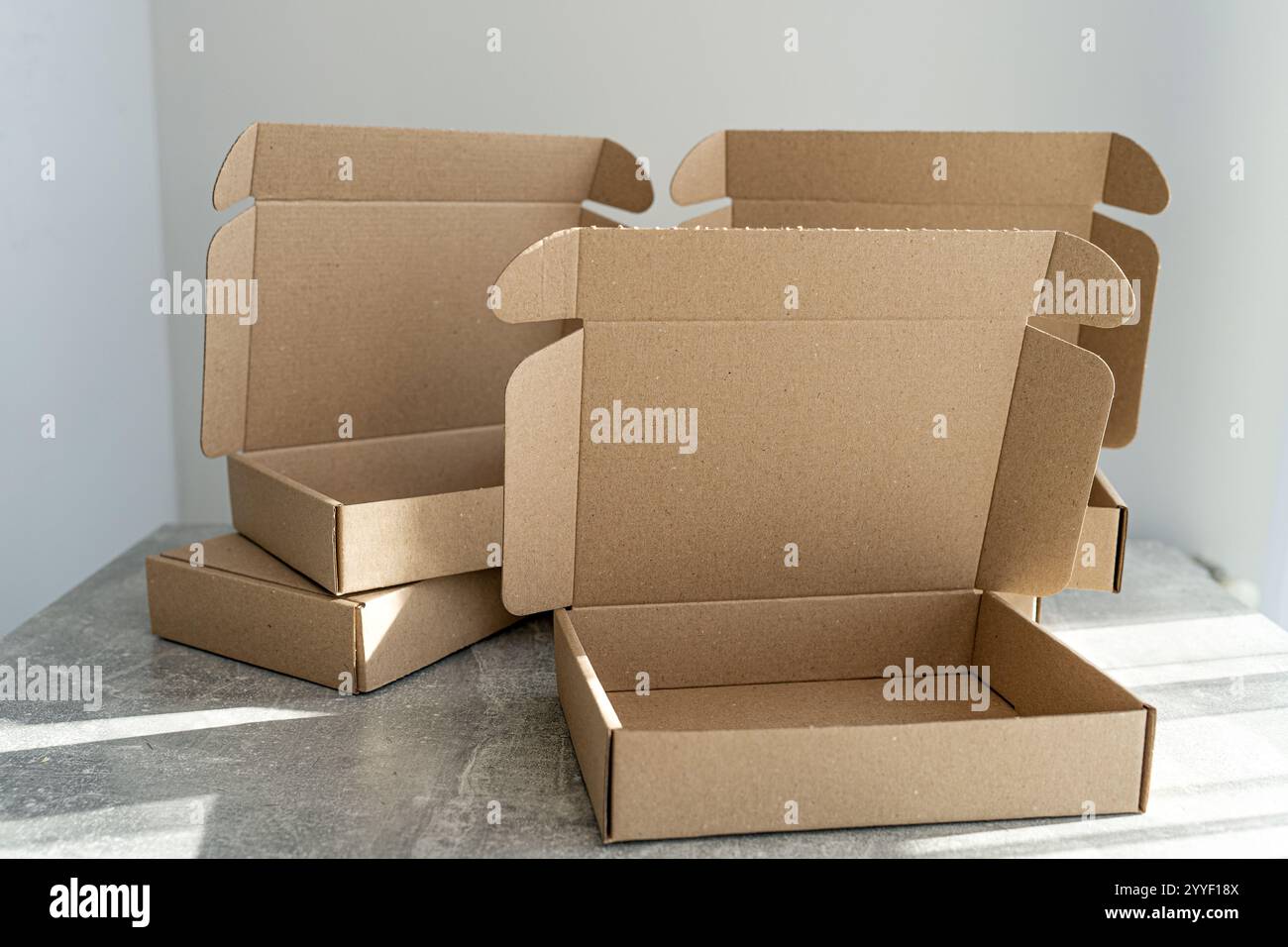 Three kraft cardboard boxes with Stock Photo - Alamy