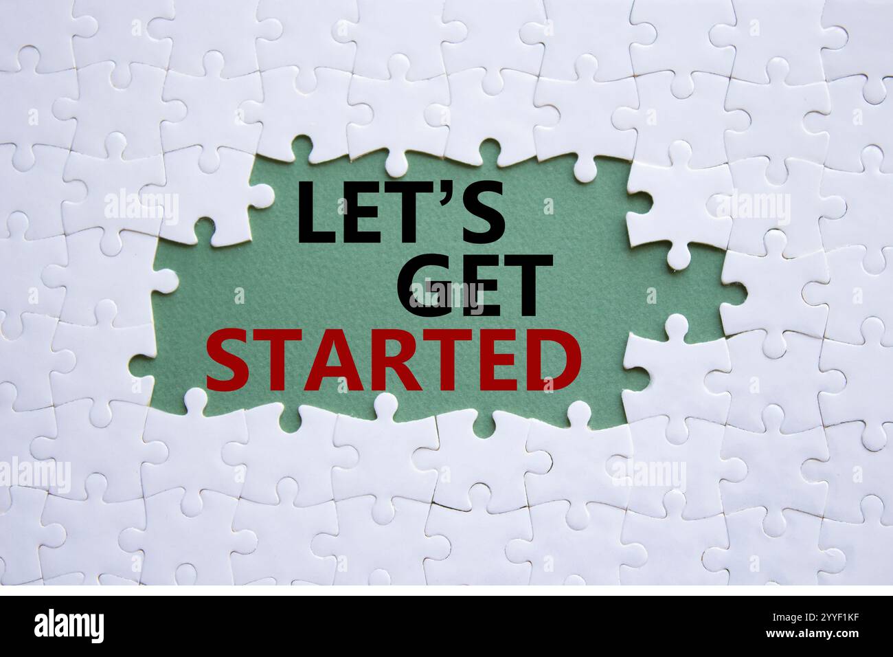 Lets get started symbol. Concept words Lets get started on white puzzle ...