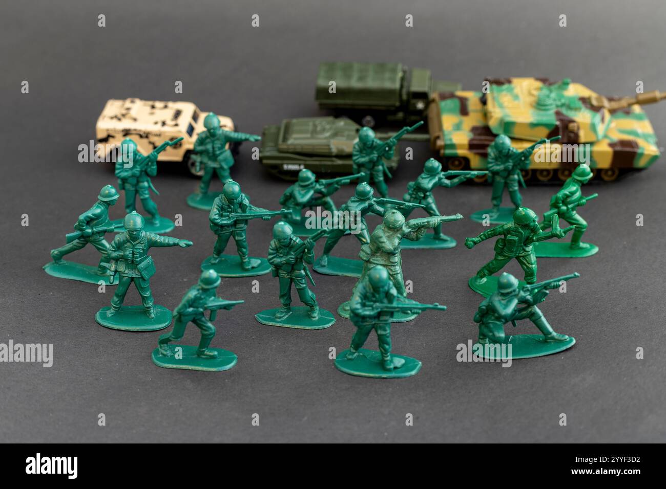 Toy soldiers with military vehicles and tanks marching towards enemy ...